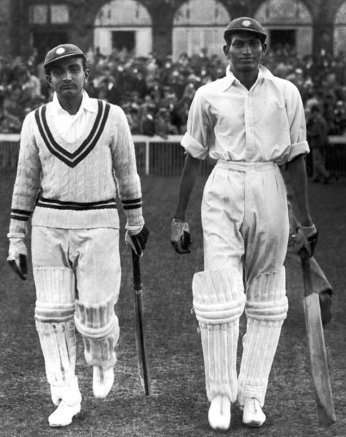 Vijay Merchant and Mushtaq Ali walk out to open the innings ...