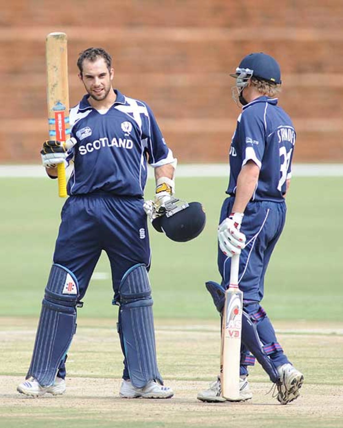 Kyle Coetzer is congratulated by Jan Stander on reaching his century ...