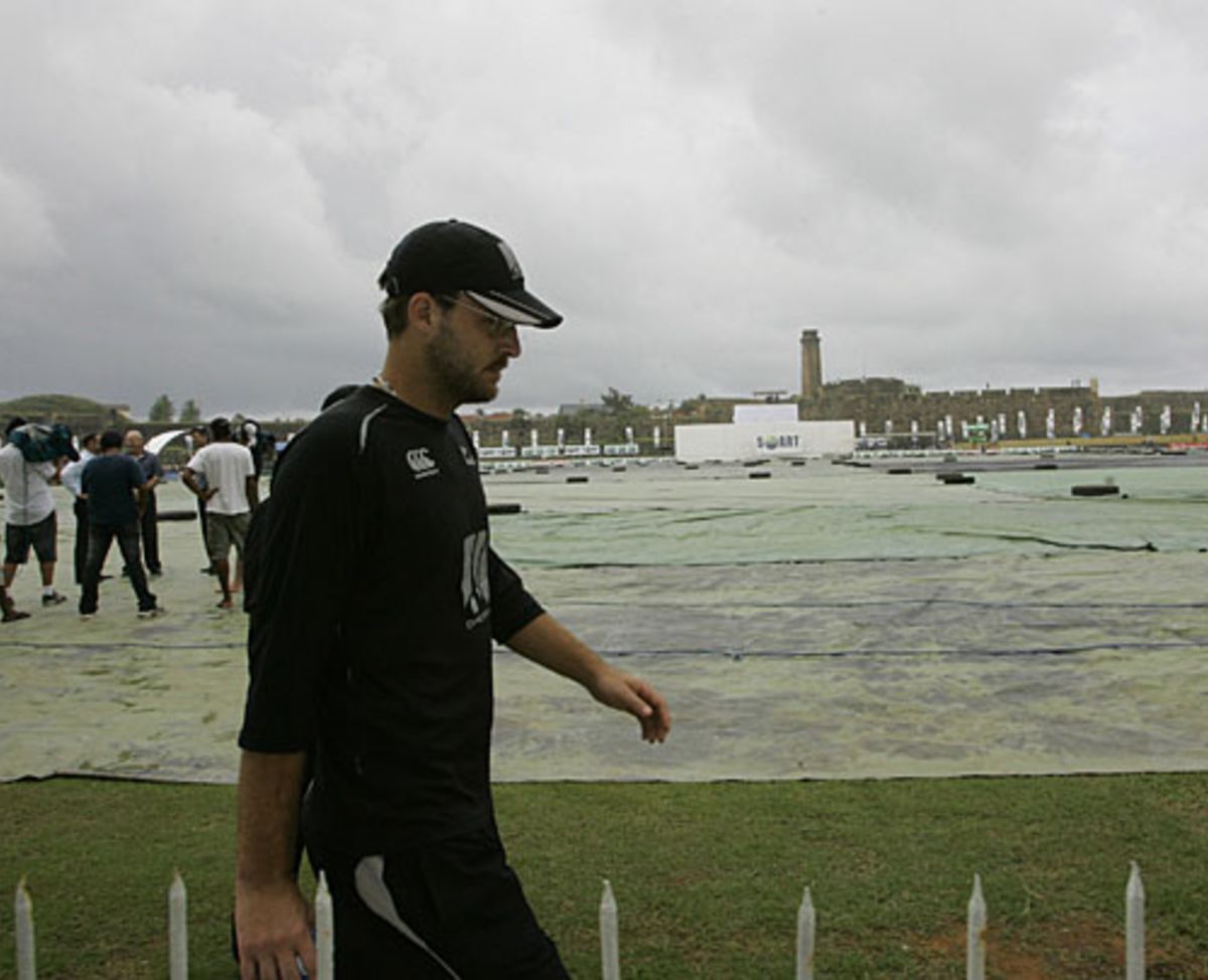 Daniel Vettori in discussion with umpires Daryl Harper and Nigel Llong ...