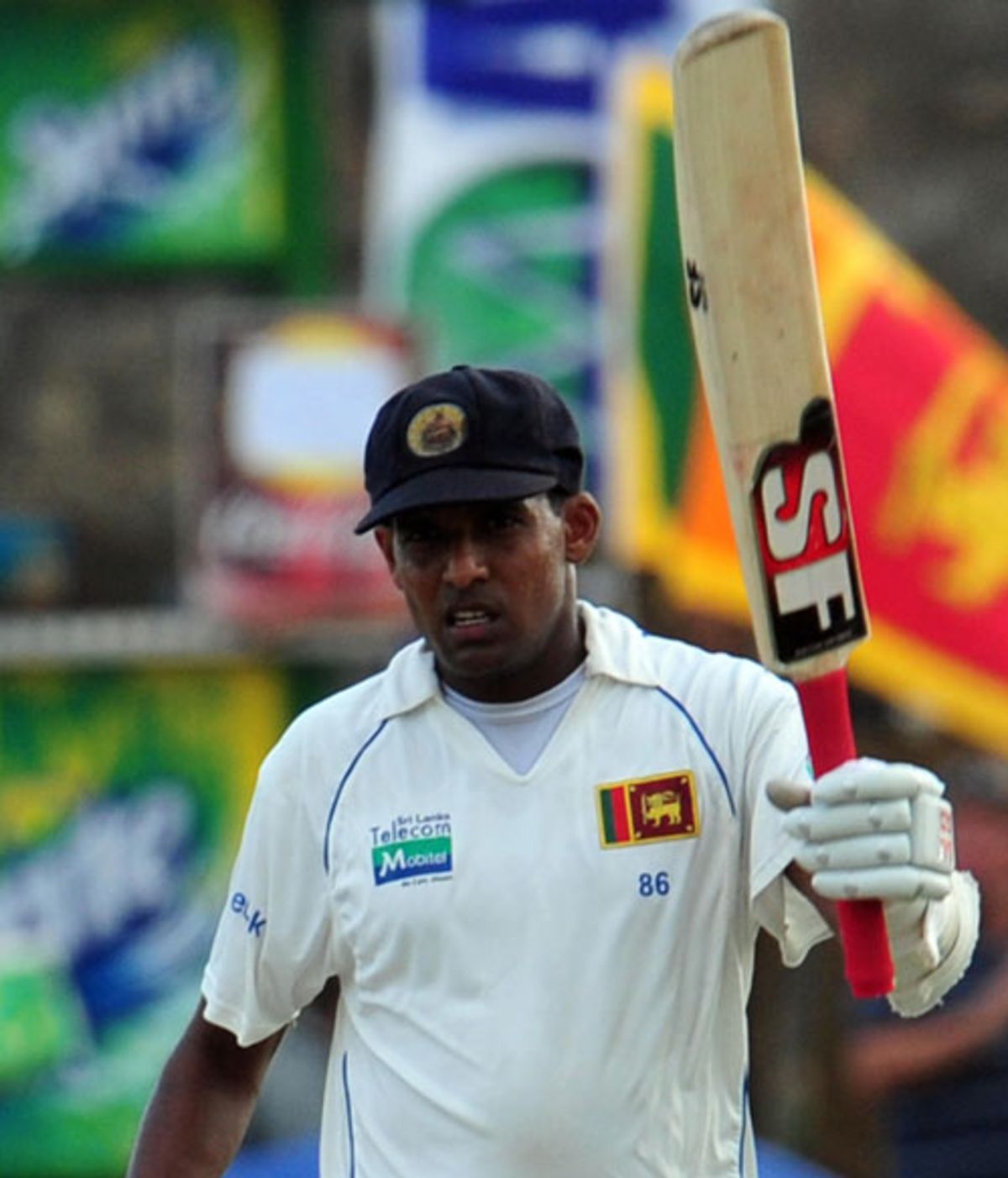 Thilan Samaraweera raises his bat after reaching his half-century ...
