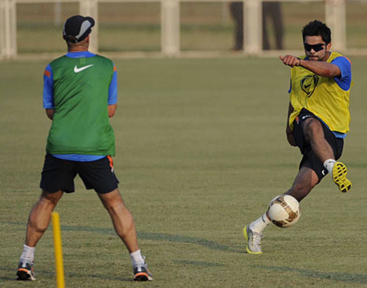 Virat Kohli scores a goal during a practice football match ...