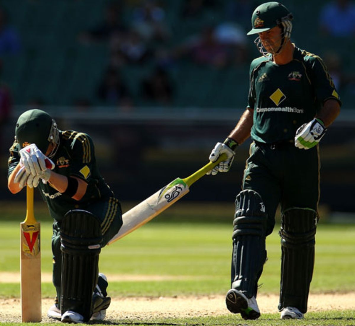Ricky Ponting checks on Michael Clarke after he was hit in the groin ...