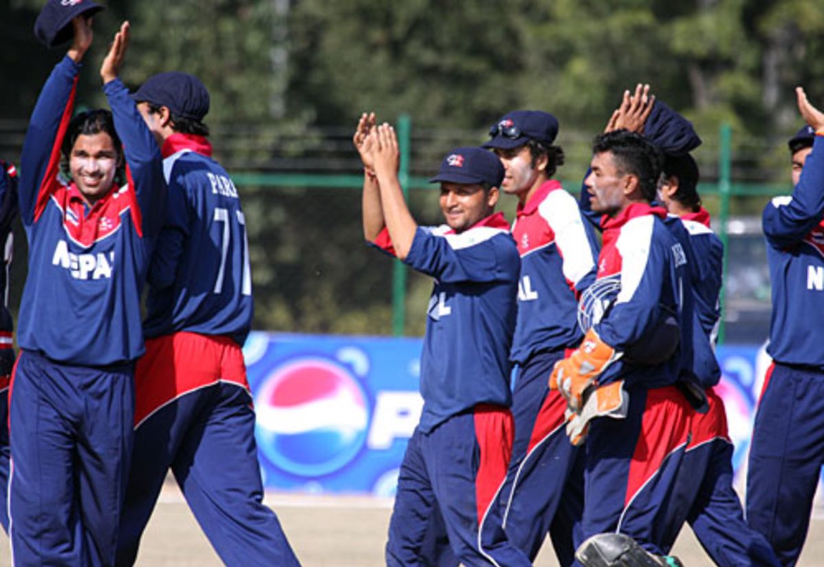 Basanta Regmi is congratulated by Gyanendra Malla and Paras Khadka ...