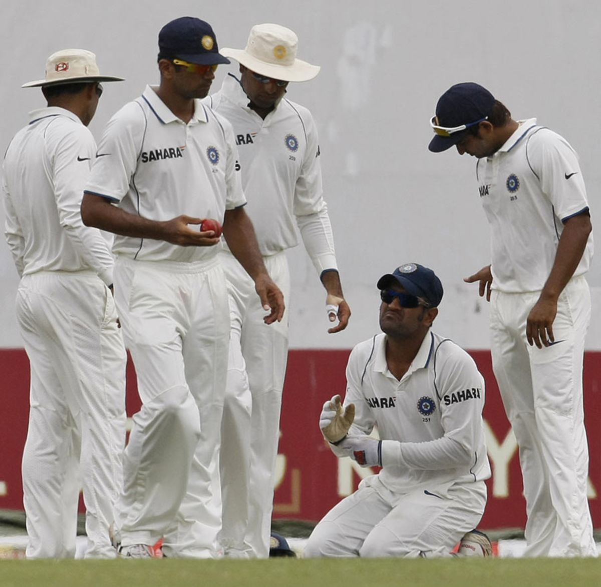MS Dhoni has his finger examined by Indian physiotherapist Nitin Patel ...