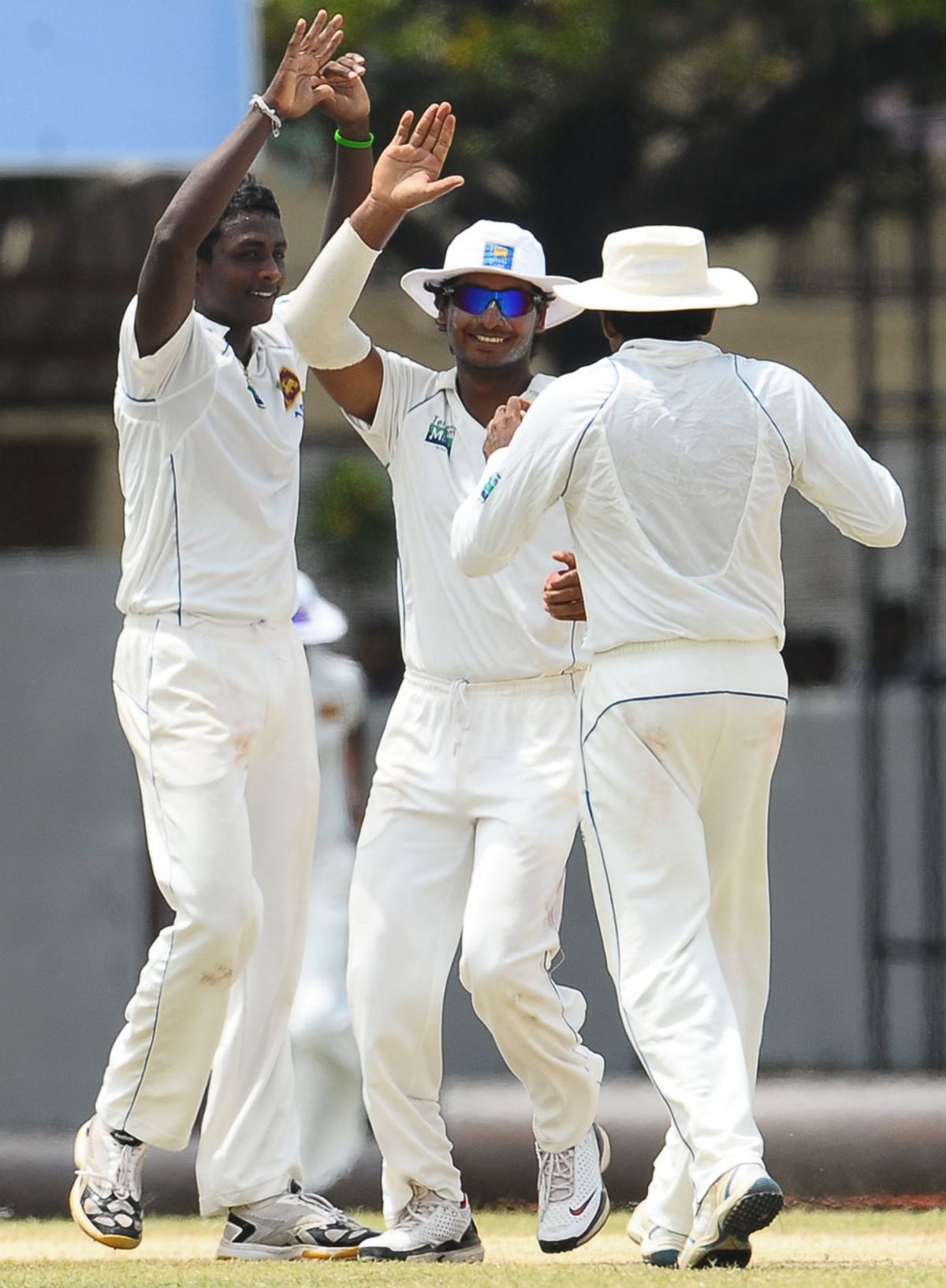 Ajantha Mendis celebrates the fall of Suresh Raina with his team-mates ...