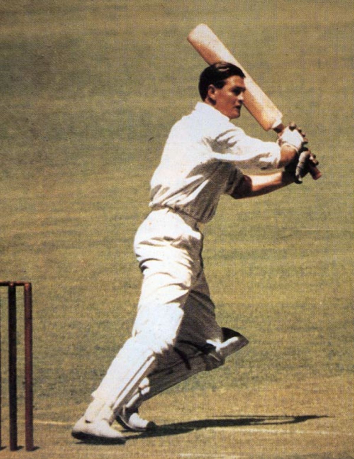 Keith Miller admires his statue during a ceremony at the MCG ...