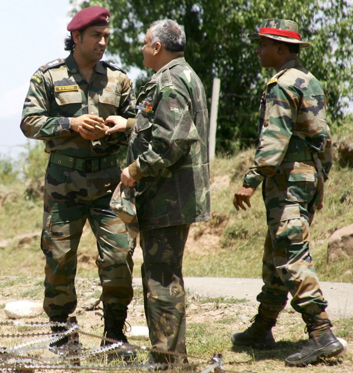 MS Dhoni talks to army officials during a visit to the India-Pakistan ...