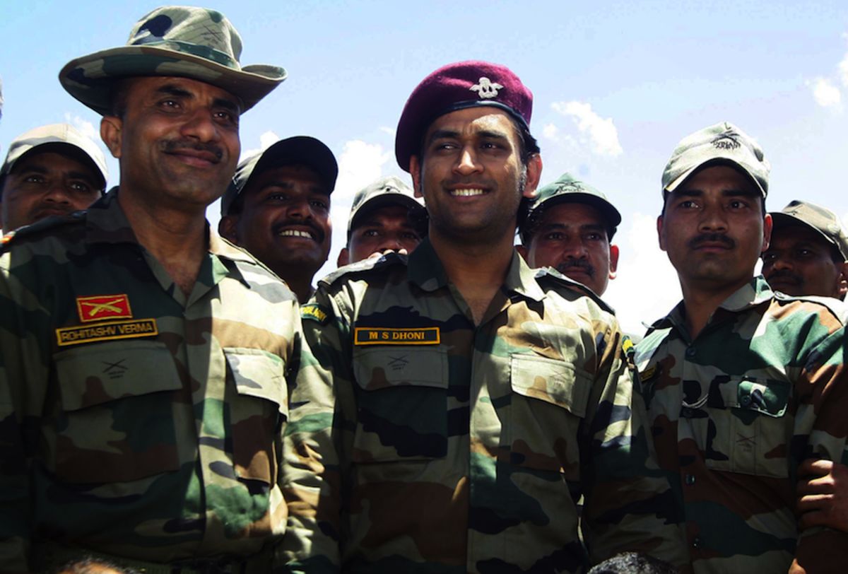 MS Dhoni talks to army officials during a visit to the India-Pakistan ...