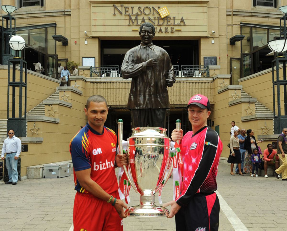 Alviro Petersen and Brad Haddin stand alongside the CLT20 trophy ahead ...