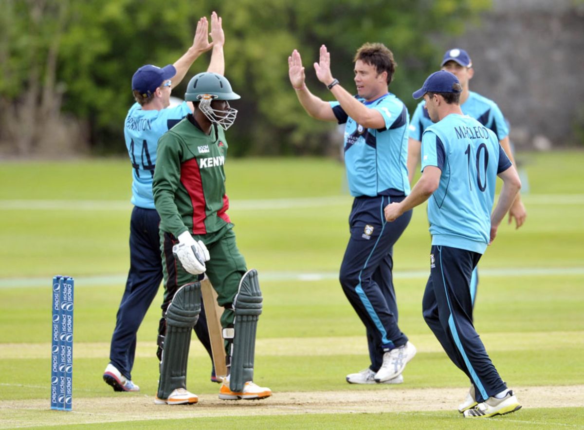 Neil Carter celebrates with team-mates after dismissing Alex Obanda ...
