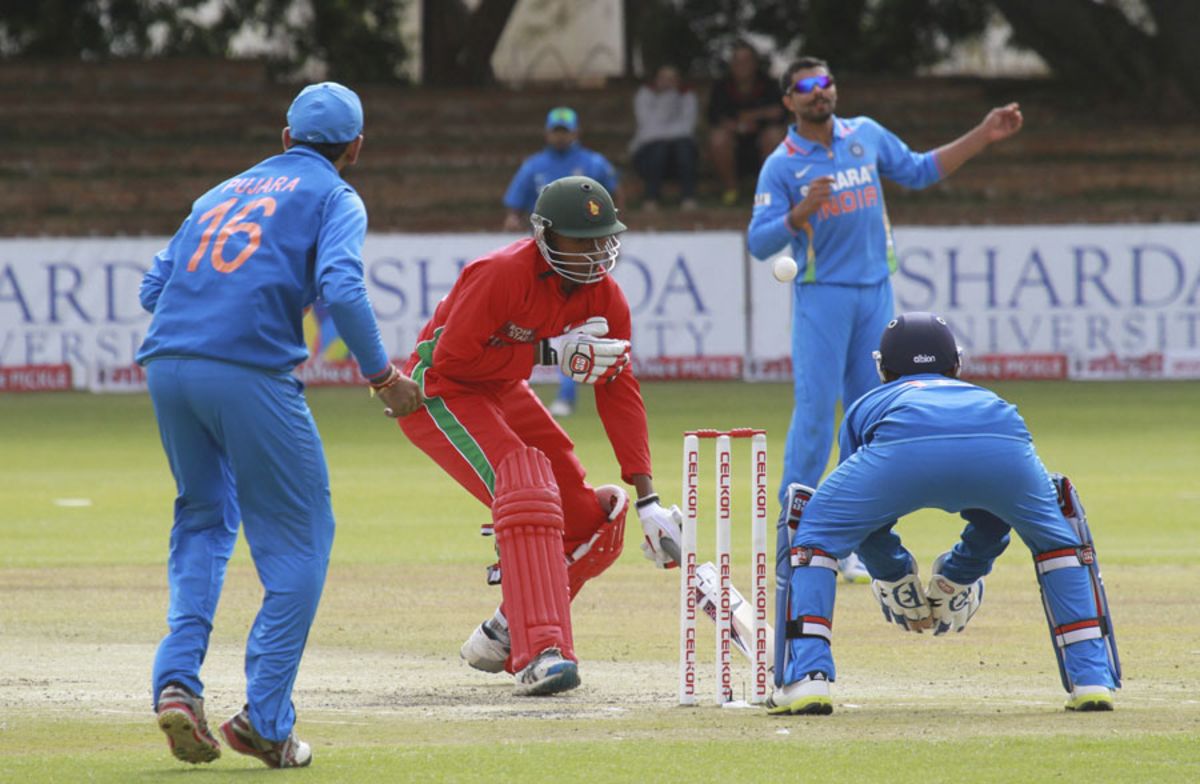 The Indian players celebrate the wicket of Hamilton Masakadza ...