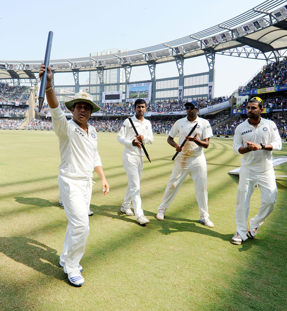 Sachin Tendulkar's team-mates clap him off the field after his final ...