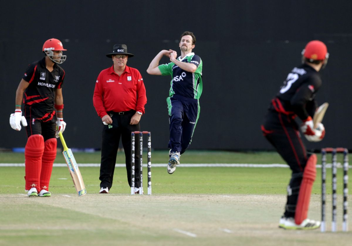 Alex Cusack of Ireland comes in to bowl against Hong Kong alongside ...