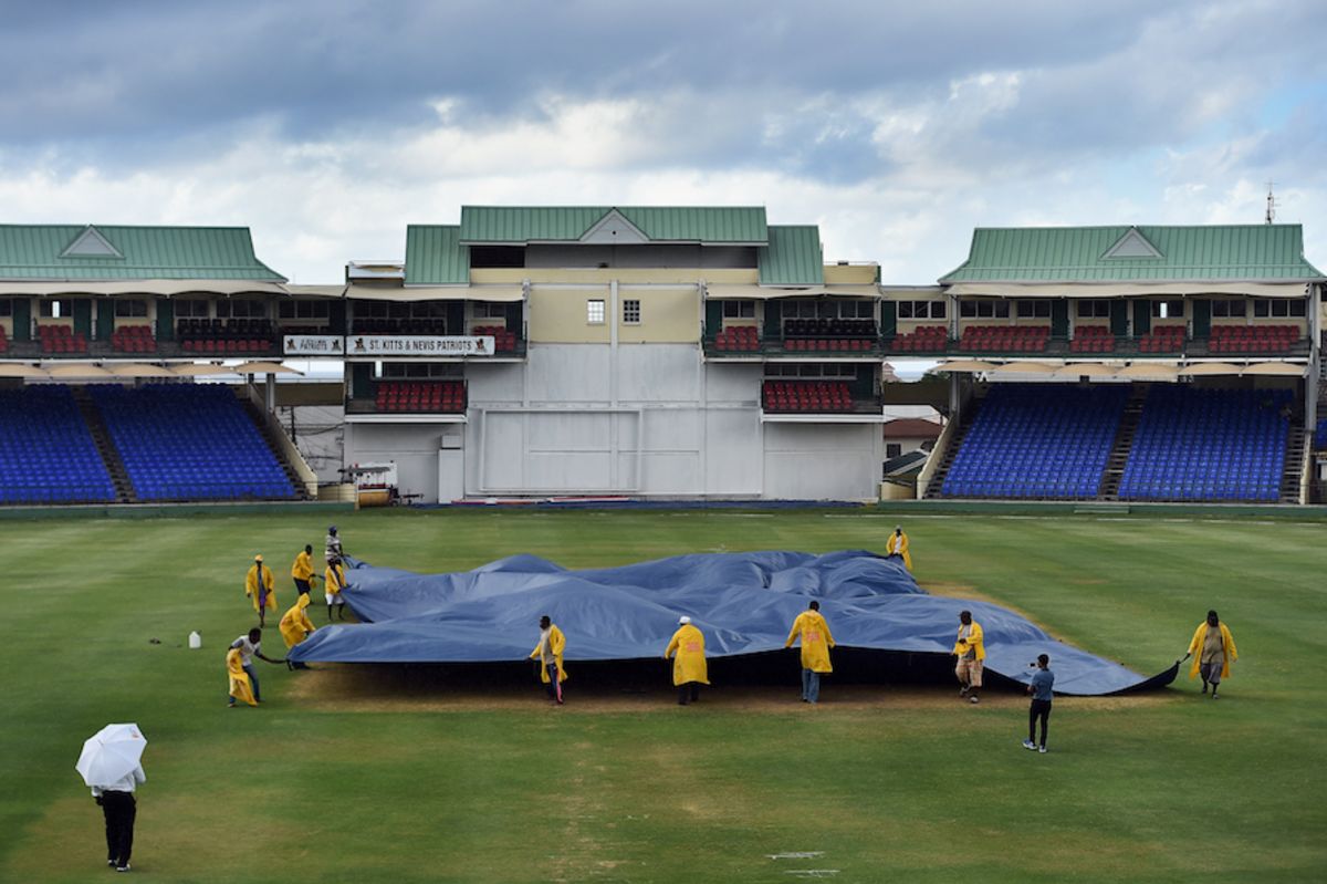 Groundsmen cover the pitch at Warner Park | ESPNcricinfo.com