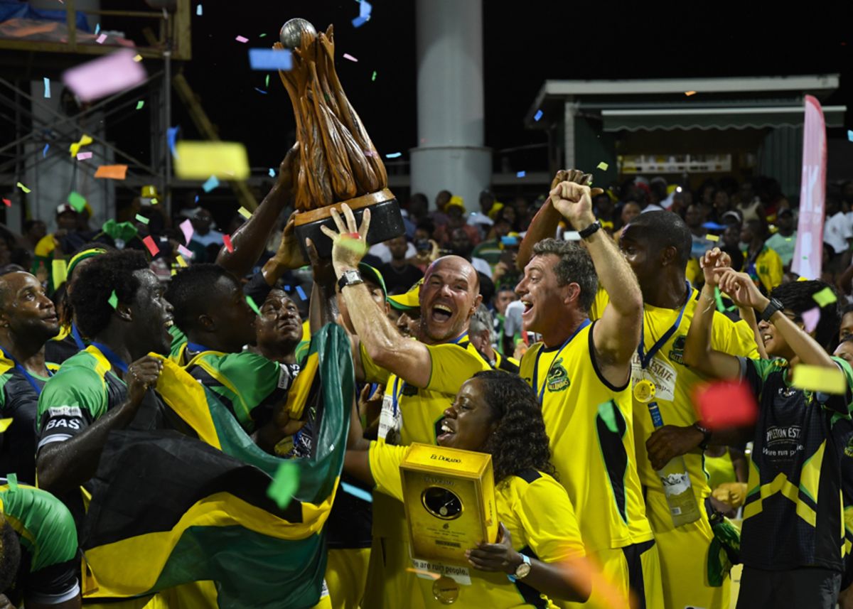 Tallawahs players and coaching staff hold the CPL trophy aloft ...