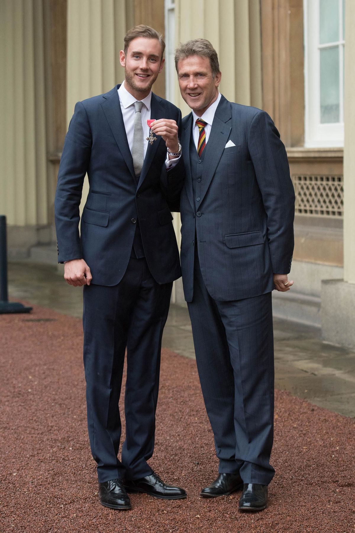 Stuart Broad poses with his MBE alongside his father Chris Broad ...