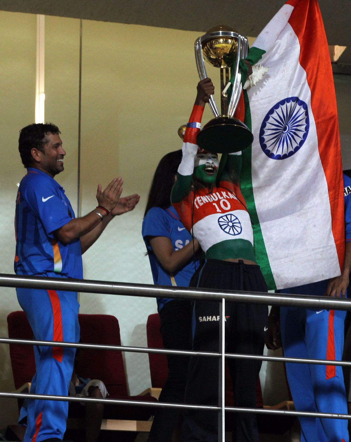 Sachin Tendulkar smiles and looks at his fan Sudhir Gautam lift the ...