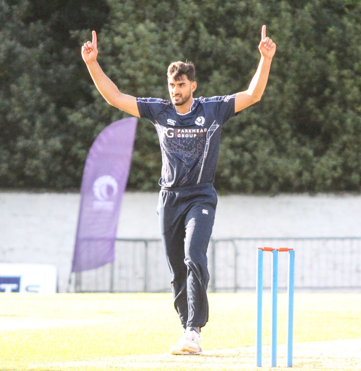 Safyaan Sharif holds his arms aloft after taking the final wicket ...