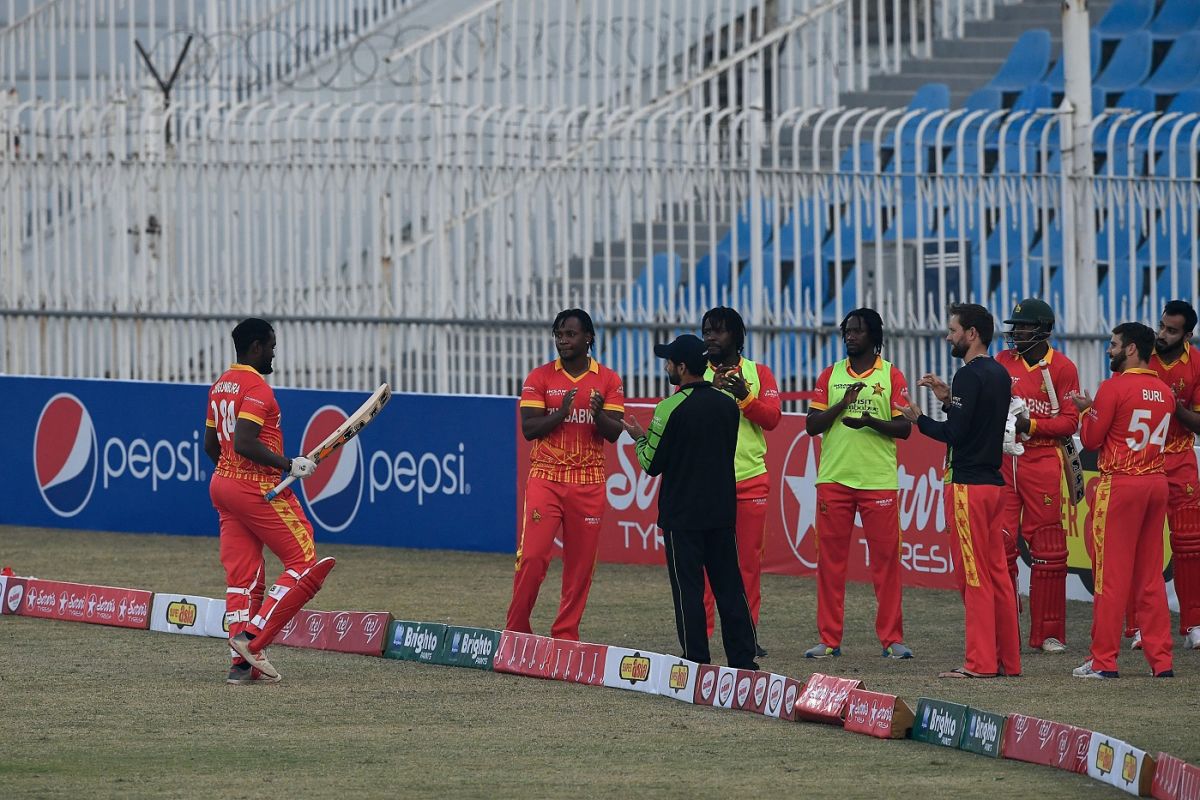The Zimbabwe players give Elton Chigumbura a guard of honour in his ...