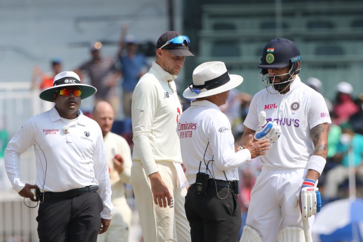 Umpire Virender Sharma jogs off the park as rain delays play ...