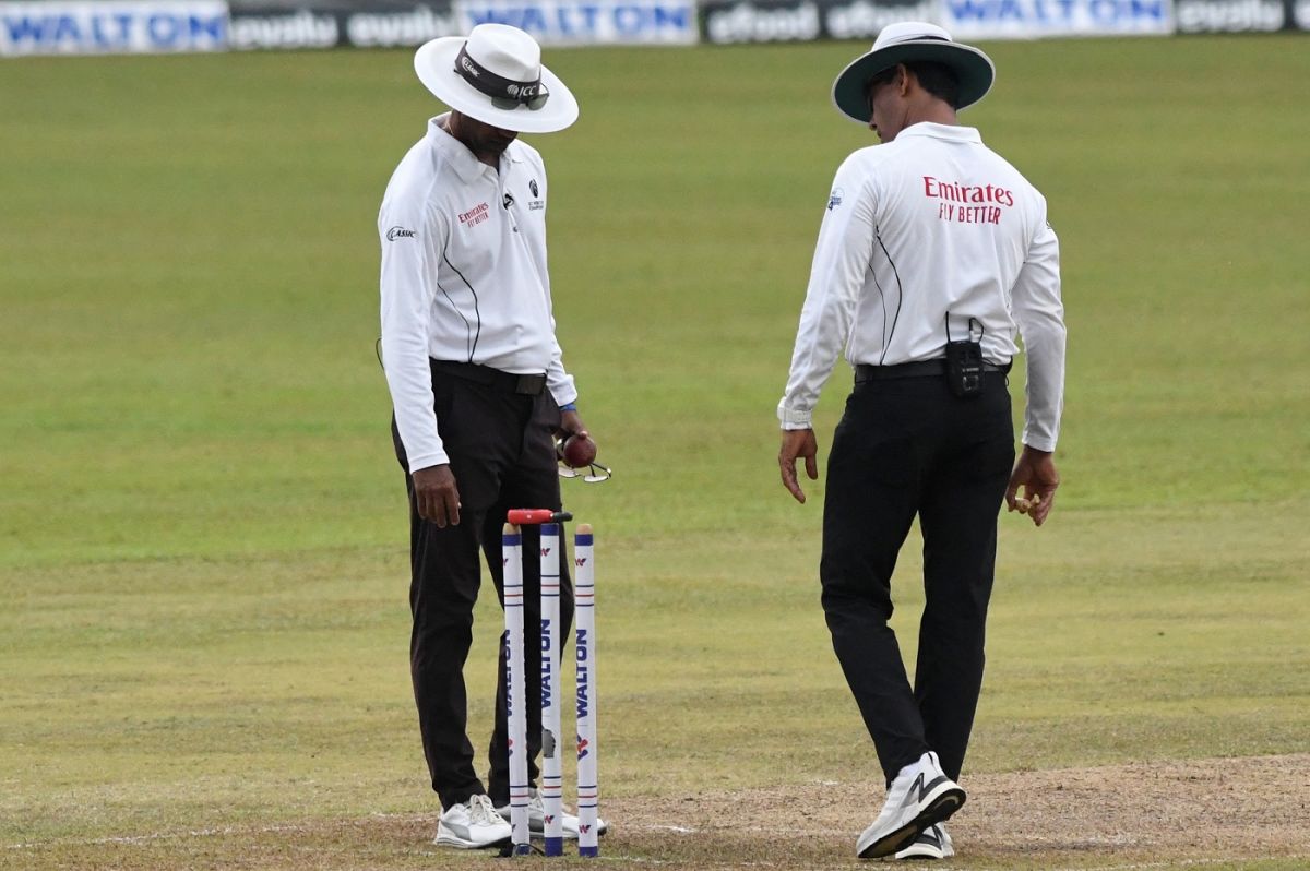 Umpires Kumar Dharmasena and Ruchira Palliyaguruge check the light on a ...