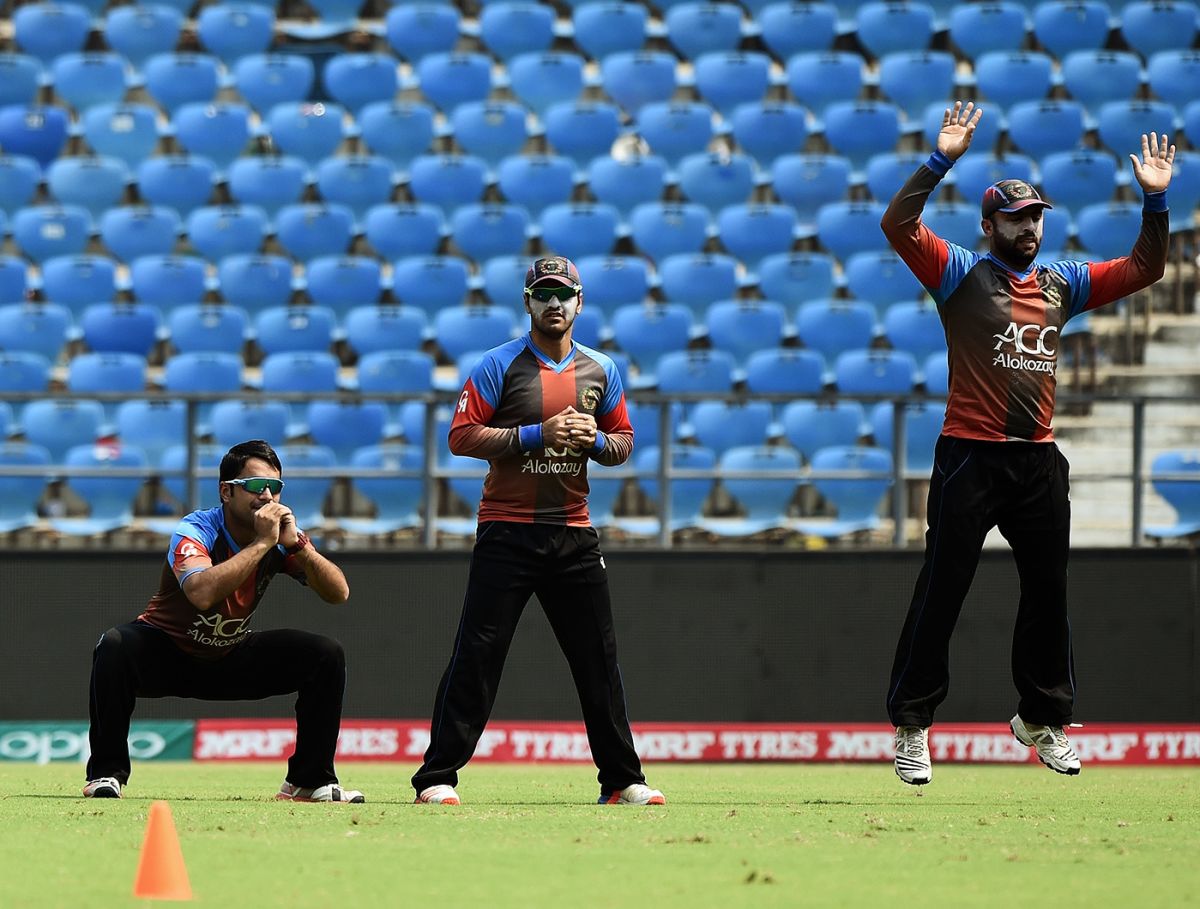 Rashid Khan, Usman Ghani and Noor Ali Zadran warm up during practice ...
