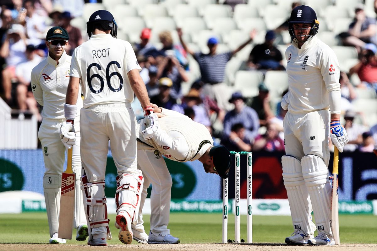 David Warner listens to the noise coming from the stump mic ...