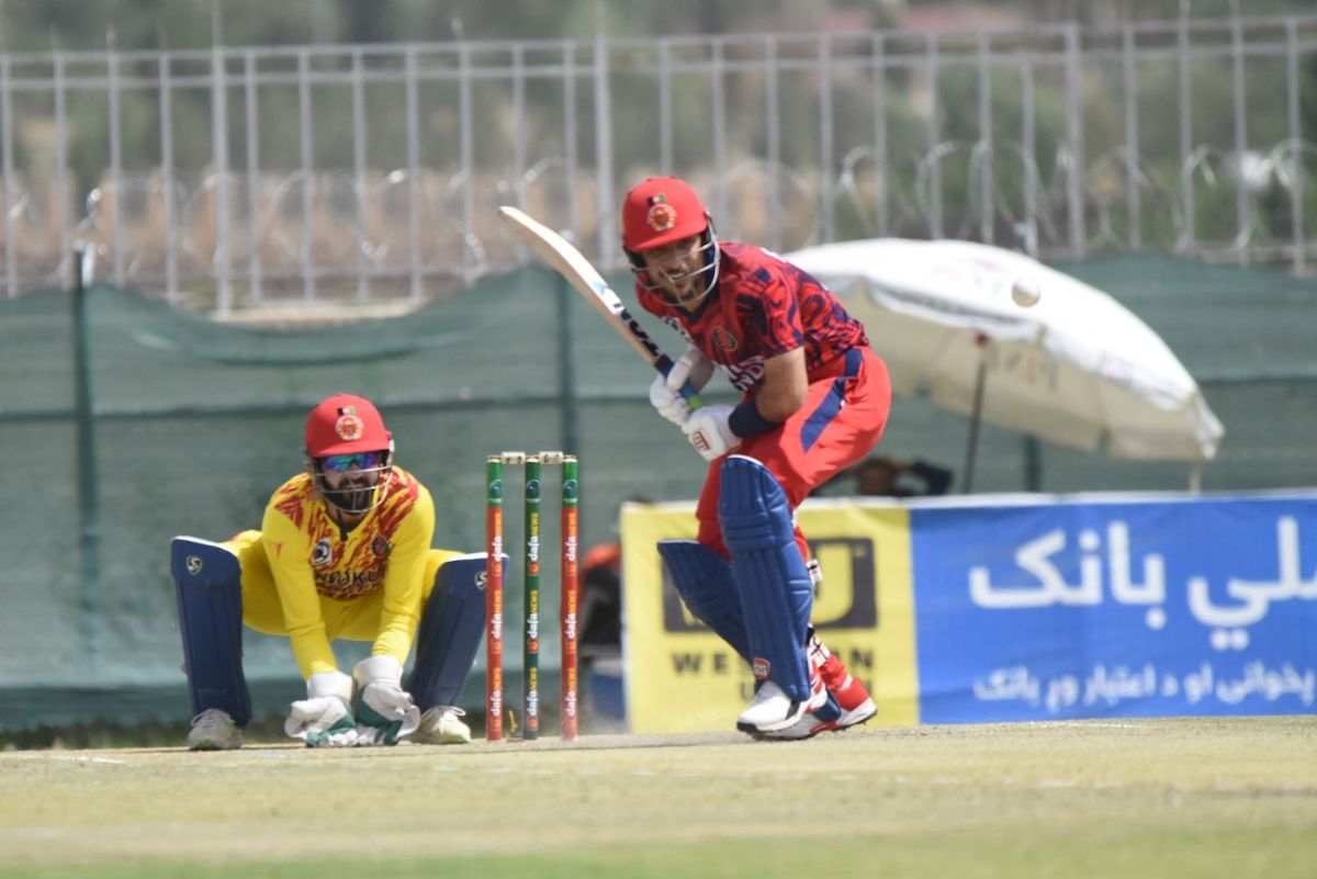 Rahmat Shah comes down the track as Afsar Zazai watches from behind ...