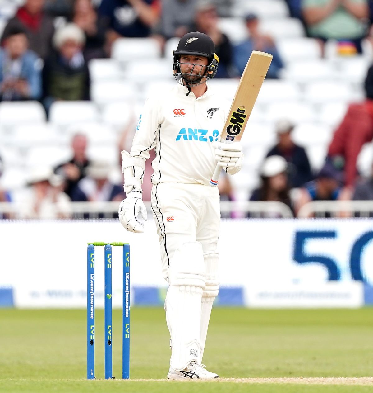 Devon Conway raises his bat after scoring a half-century | ESPNcricinfo.com
