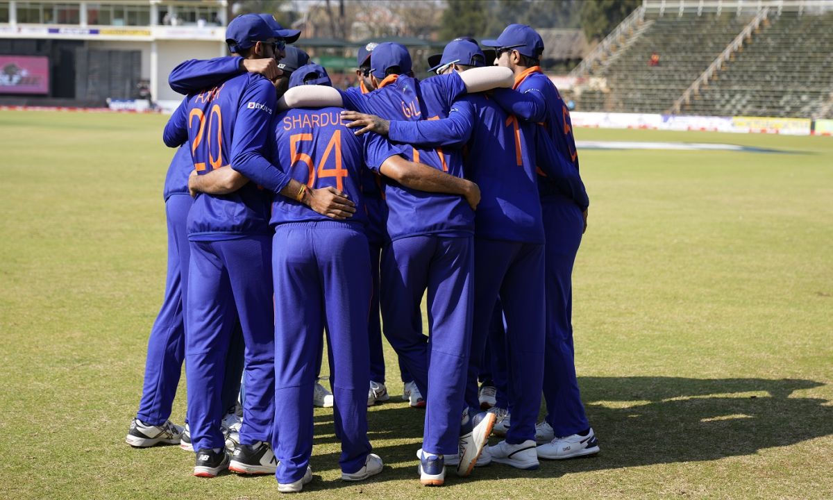 The Indians get into a customary huddle at the start of the game ...