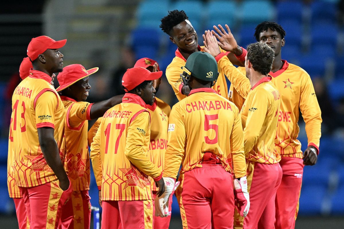 Zimbabwe's players celebrate after Johnson Charles' run out ...