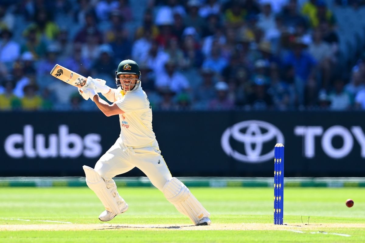David Warner raises his bat after reaching his half-century in his ...