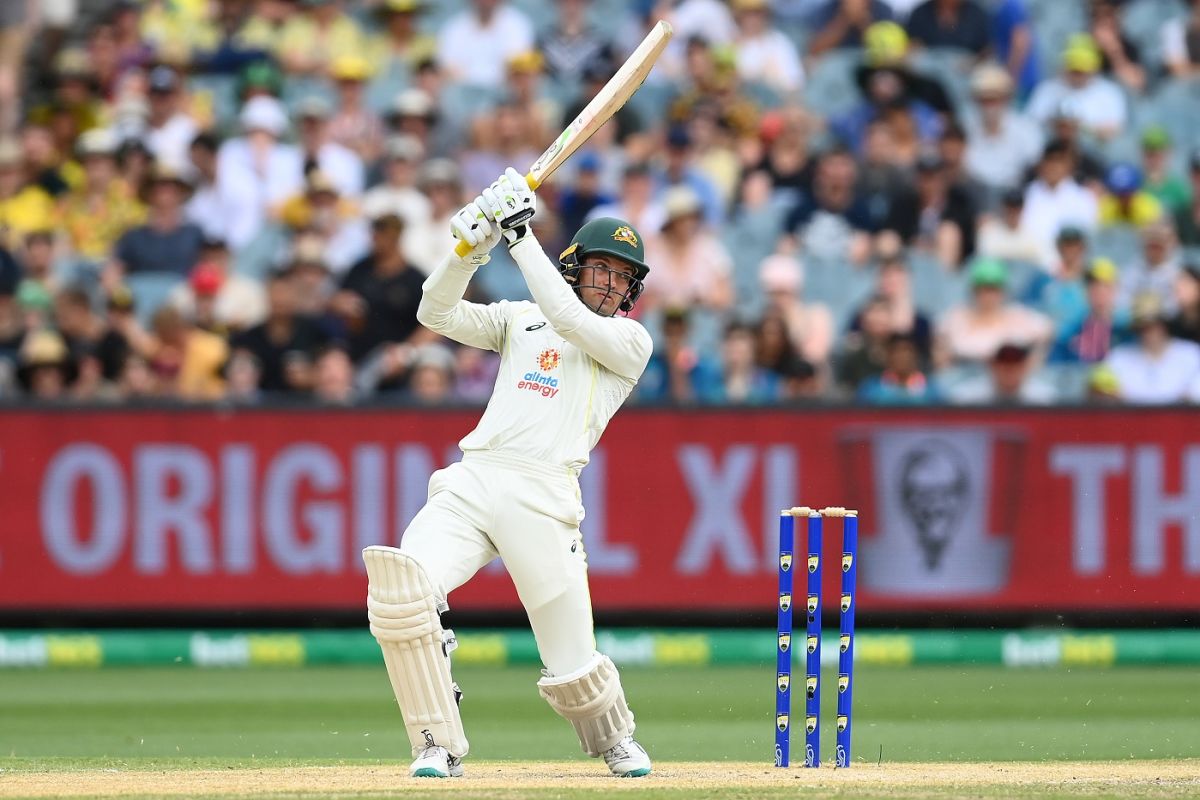 Travis Head raises his bat after reaching his fifty | ESPNcricinfo.com