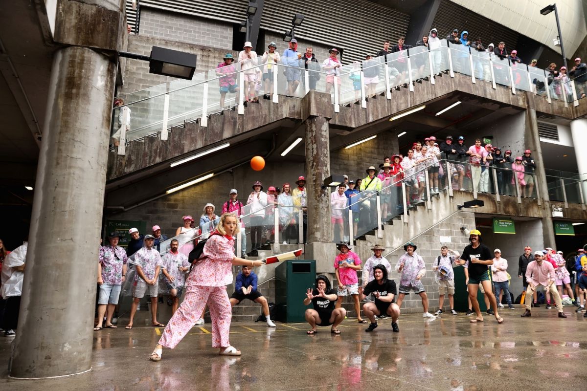 Spectators play an impromptu game of cricket behind the Victor Trumper ...