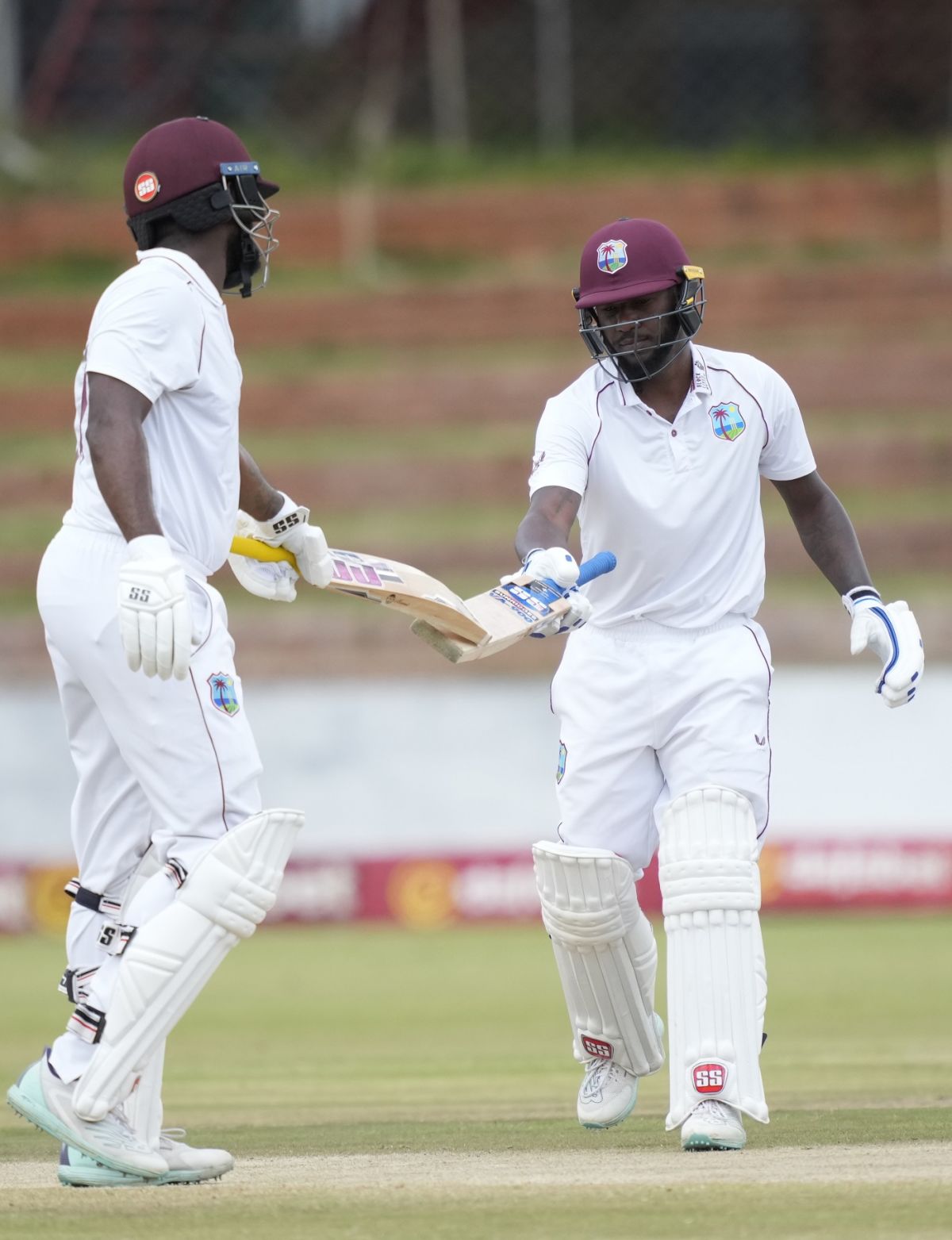 What do we have here? Pat Cummins checks under the pitch cover ...
