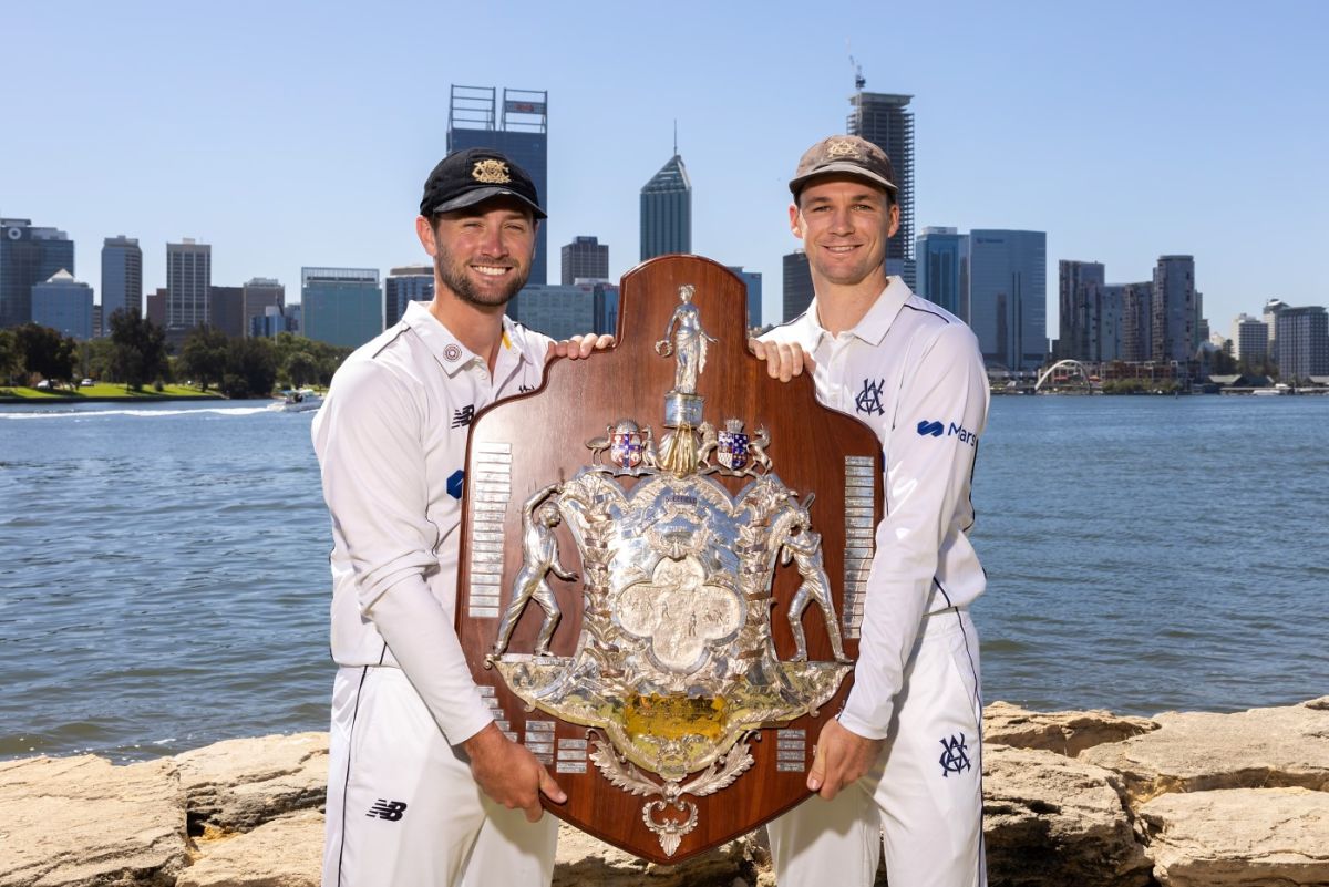 Sam Whiteman and Peter Handscomb pose with the Sheffield Shield trophy ...