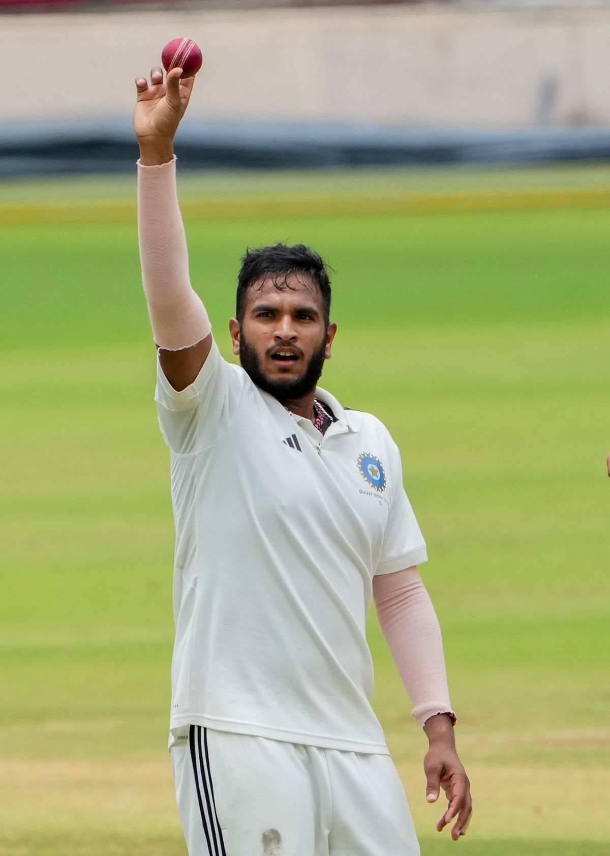 Vijaykumar Vyshak holds the ball aloft after bagging a five-wicket haul ...