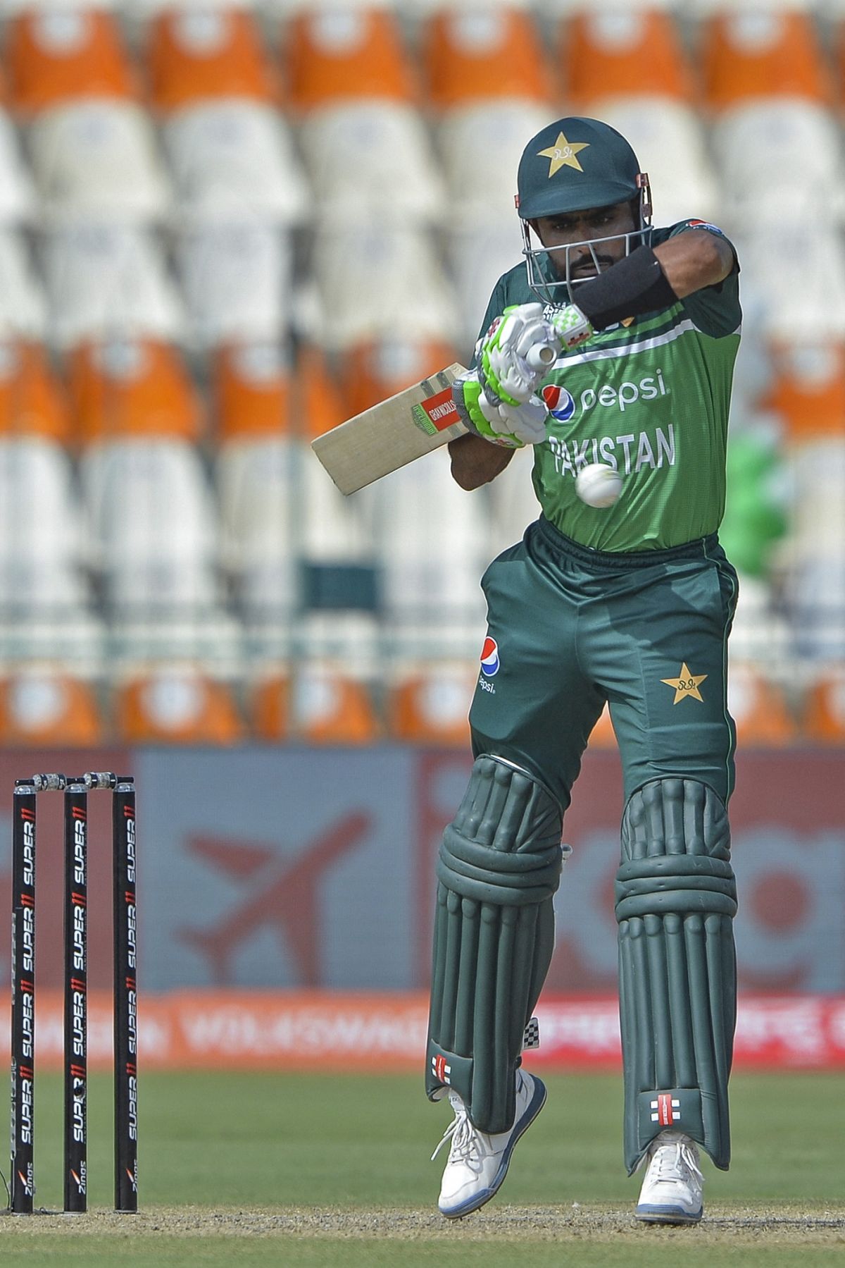 Babar Azam looks to ride the bounce while playing a short ball ...