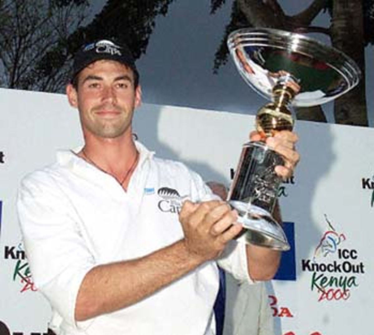The New Zealand captain Fleming holds the ICC KnockOut trophy aloft ...