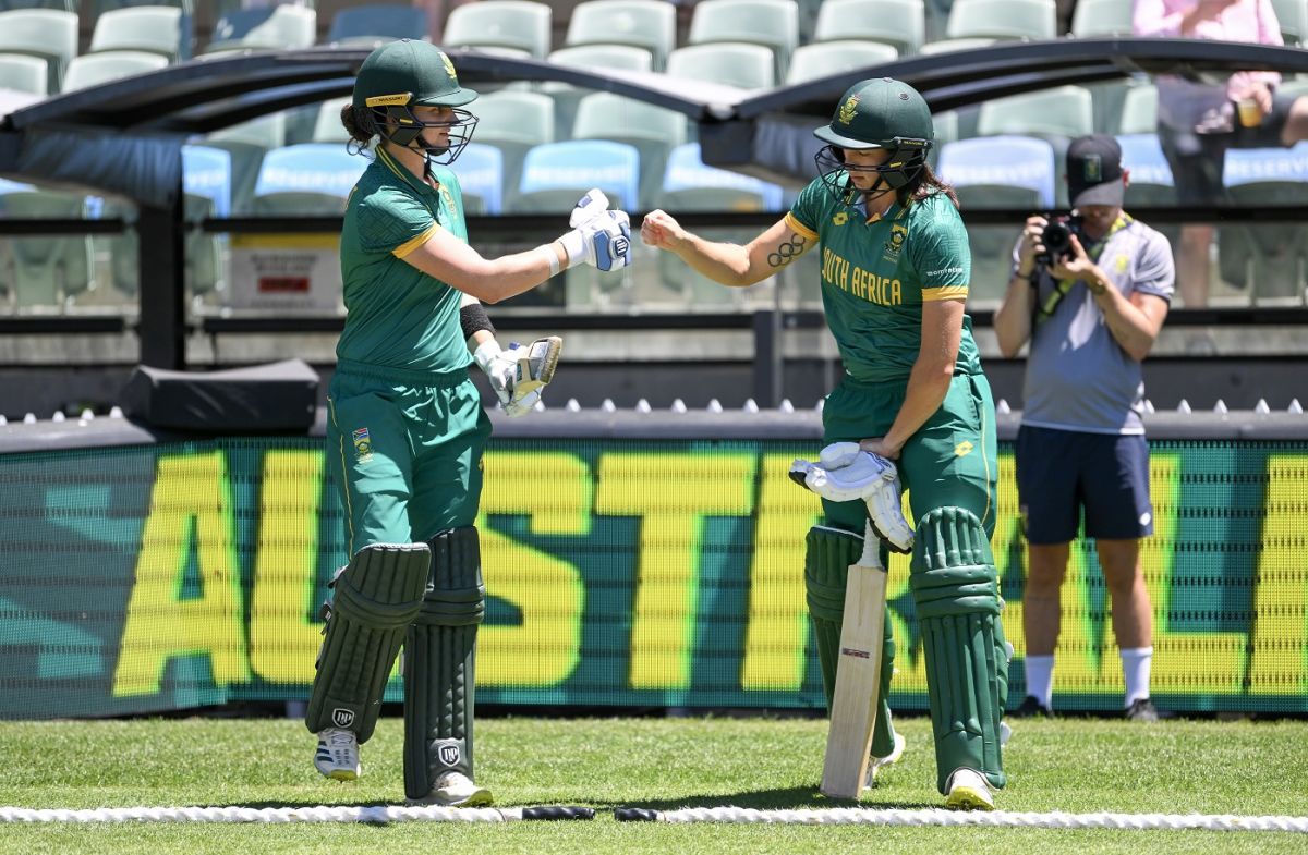 Umpires Claire Polosak and Sue Redfern are all smiles as they walk out ...