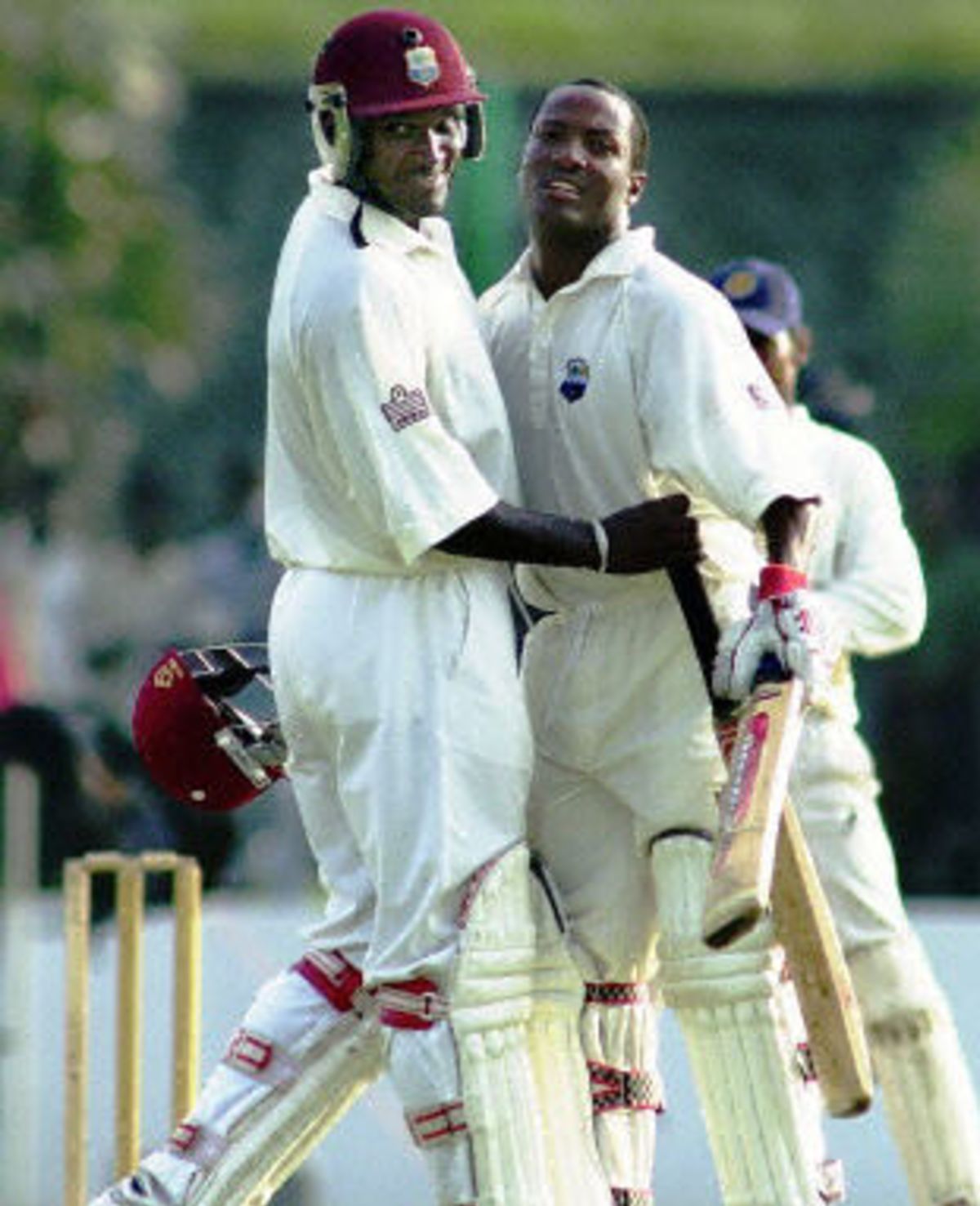 Lara, right , and skipper Hooper celebrate Lara's ton | ESPNcricinfo.com