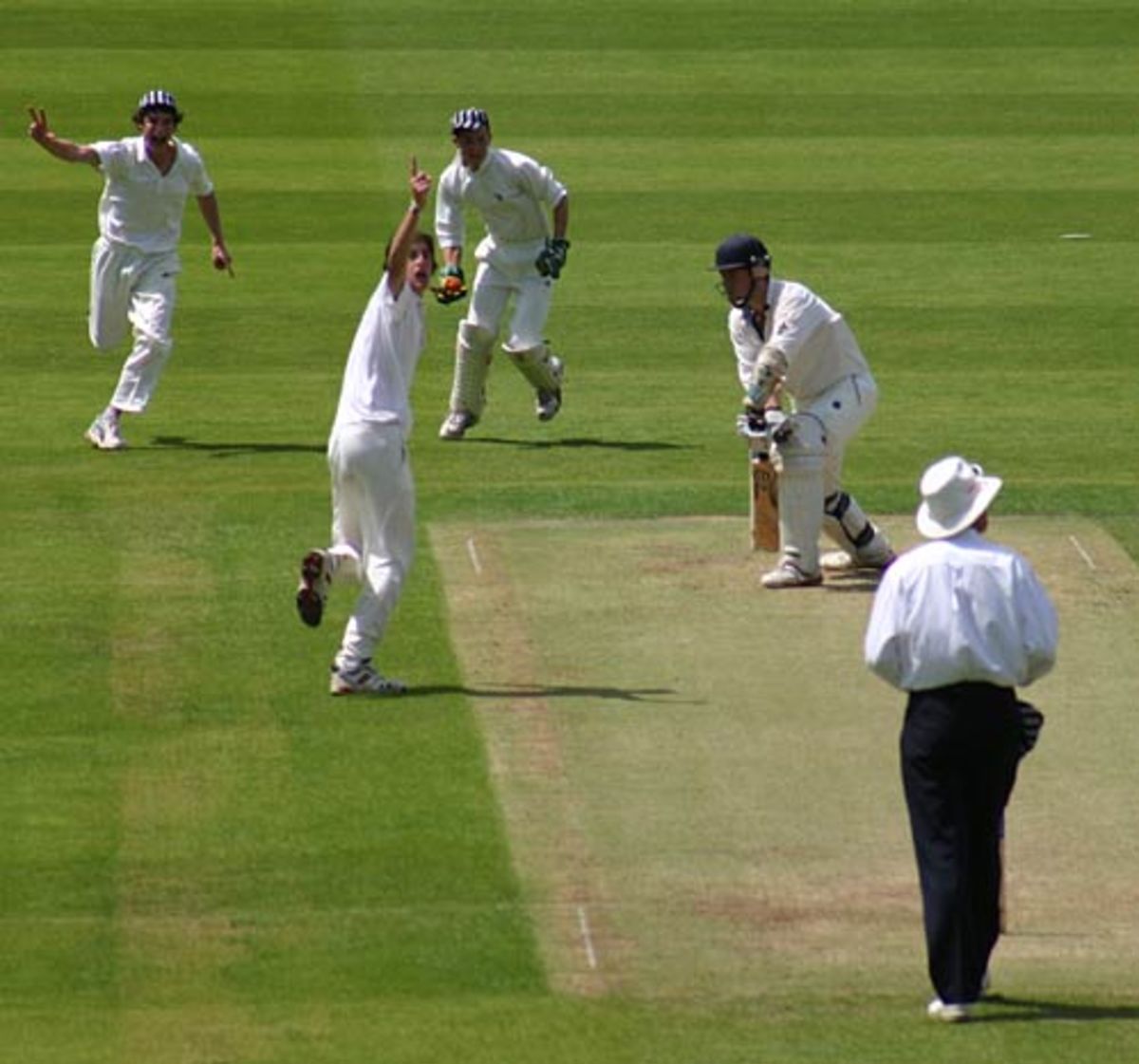 Eton's Redmayne dives for the crease, just beating Habib's shy at the ...