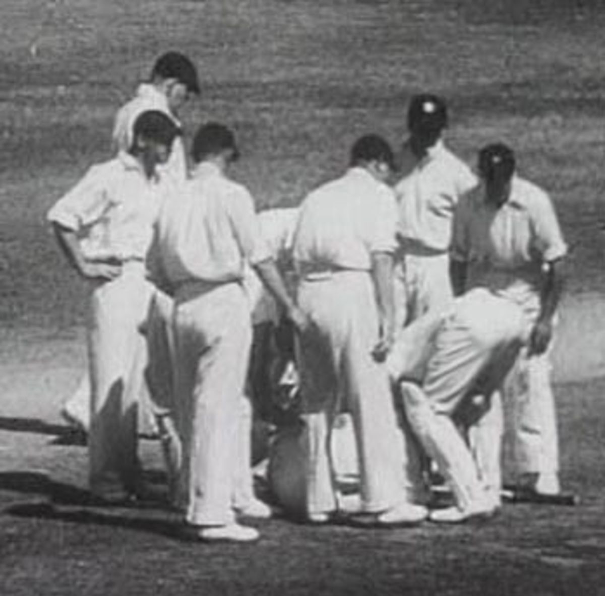 England's fielders crowd round the stricken Bert Oldfield ...