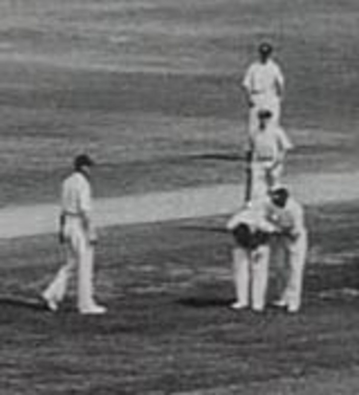 England's fielders crowd round the stricken Bert Oldfield ...