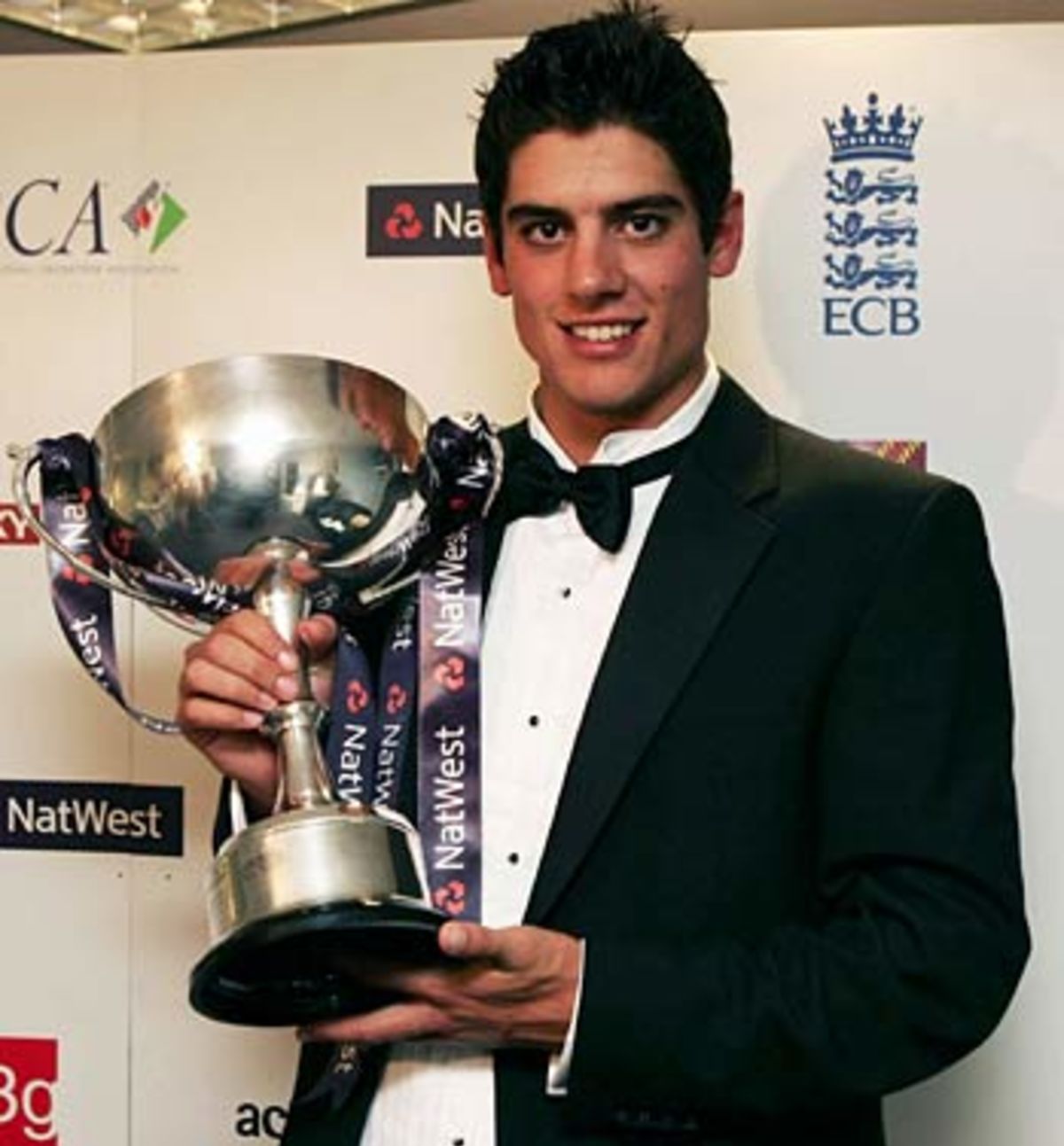 Alastair Cook holds up his trophy after being named the PCA Young ...
