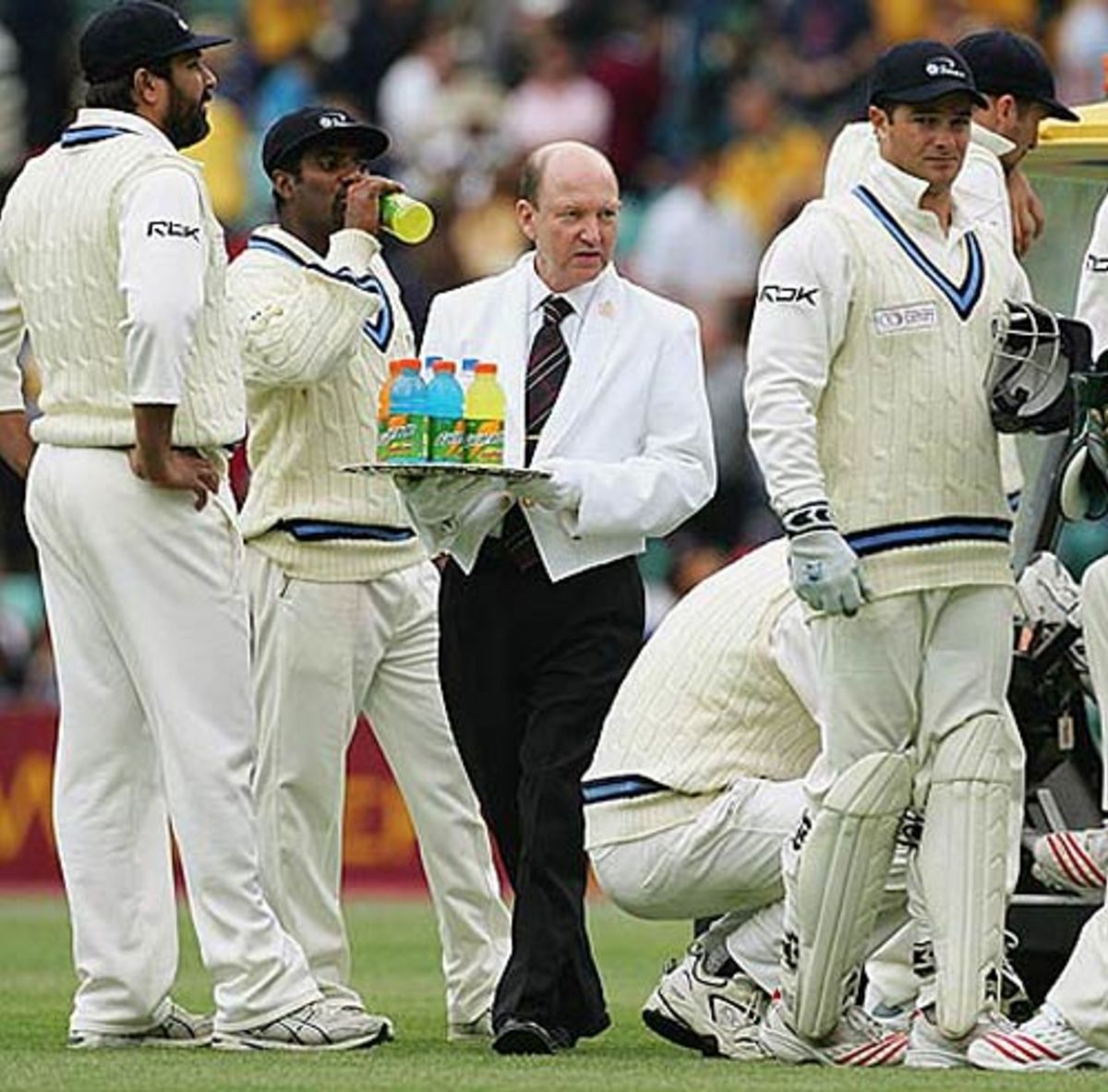 A butler in the traditional attire serves while the World XI stars ...