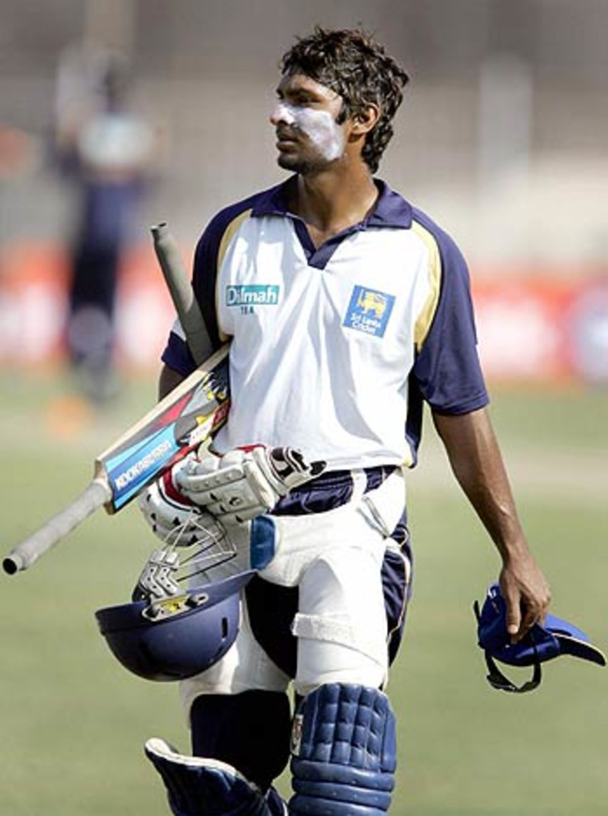 Sanath Jayasuriya finds something the bother with his helmet ...