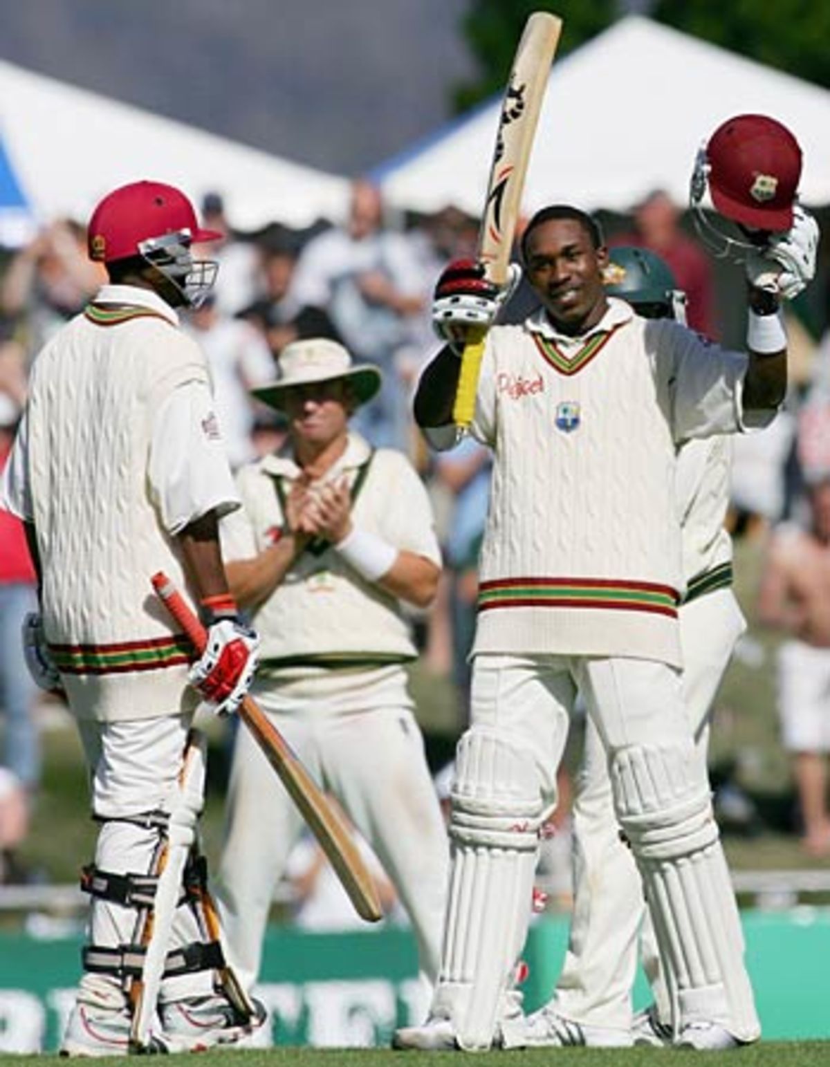 Dwayne Bravo acknowledges the applause after reaching his century as ...