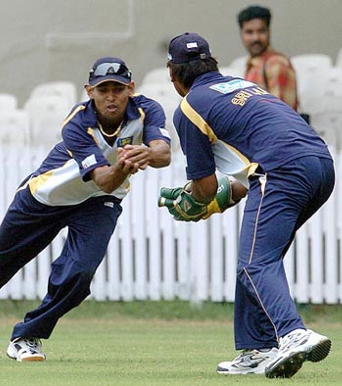 Tillakaratne Dilshan catches a ball as Kumar Sangakkara looks on ...