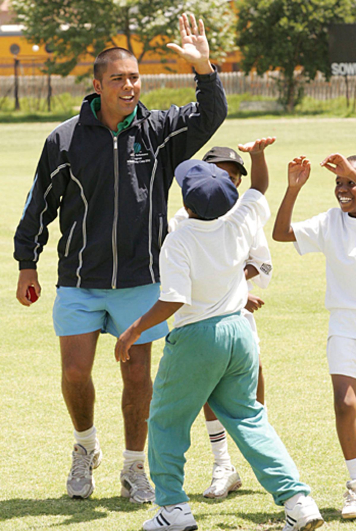 Qasion Sheika celebrates with children during a coaching clinic ...